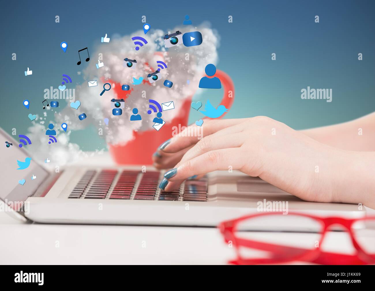 Digital composite of Hands on laptop with icons and clouds coming from ...