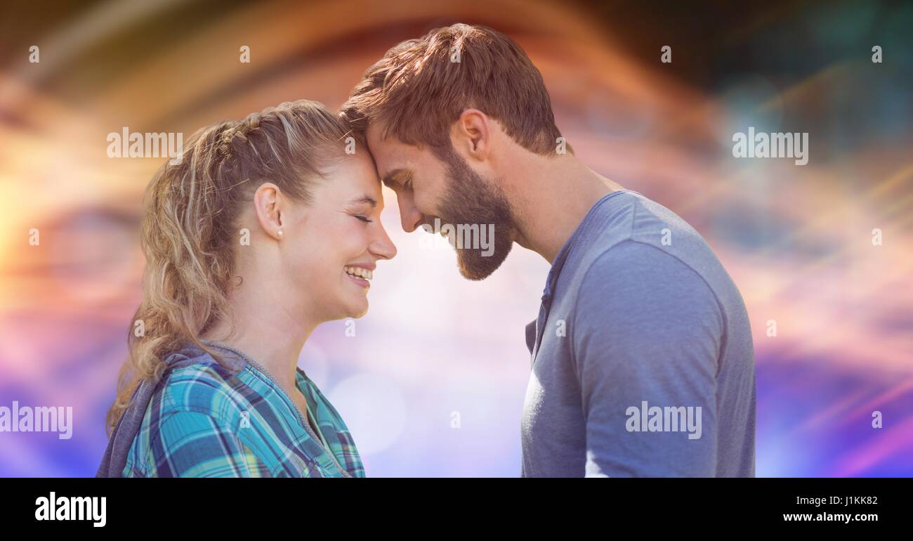Digital composite of Side view of loving couple with head to head over ...