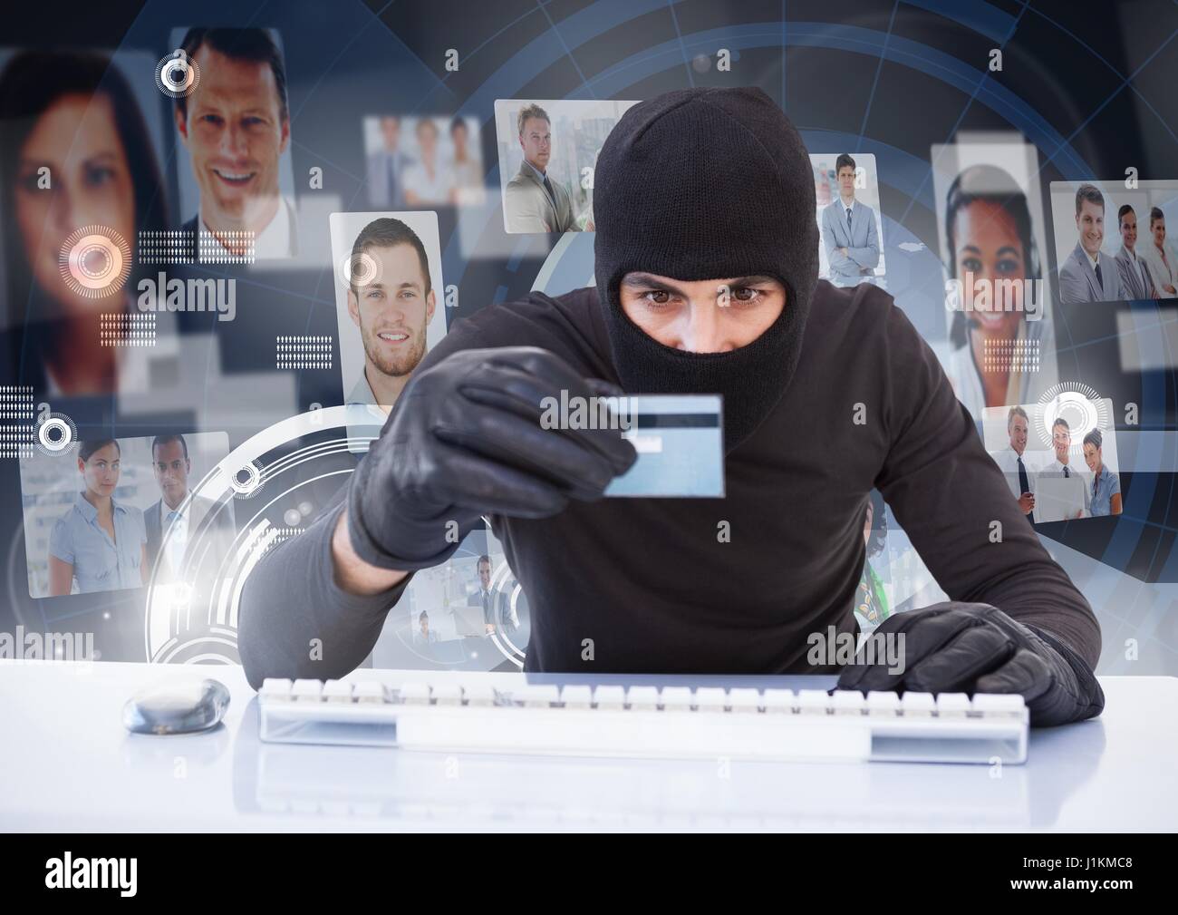 Digital composite of Criminal in hood on laptop with card in front of ...