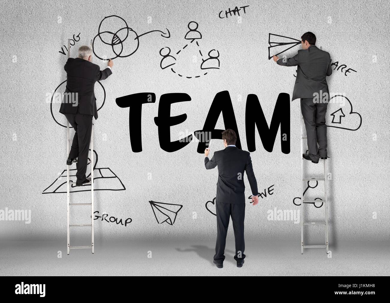 Digital composite of three men drawing a graphic about team on a wall ...