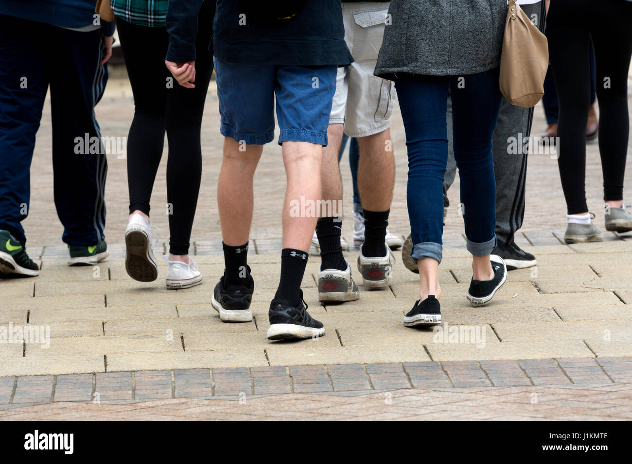 Legs of young people walking away, Stratford-upon-Avon town centre, UK ...