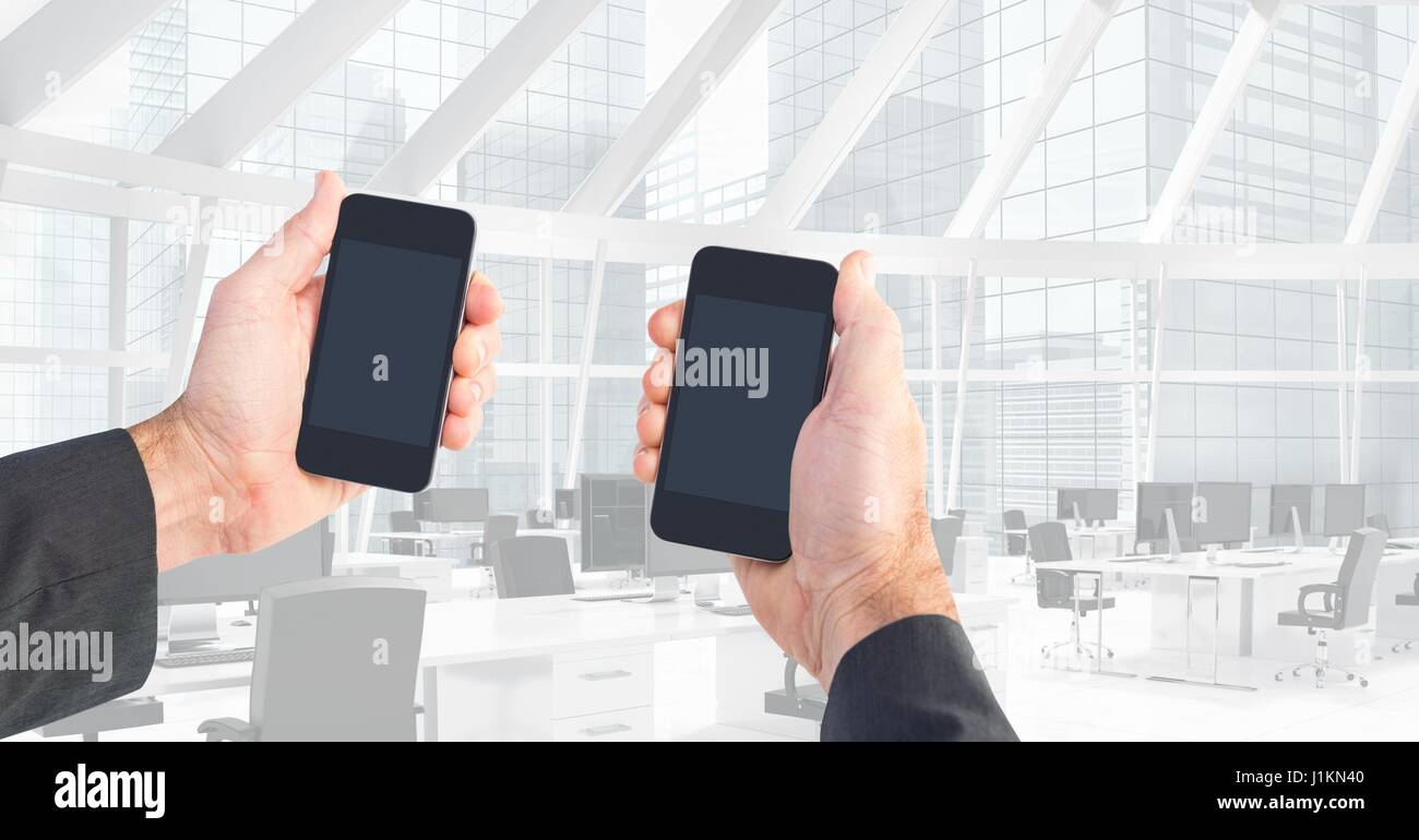 Digital composite of Cropped image of hands holding smart phones in ...