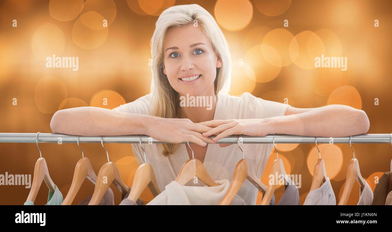 Digital composite of Woman leaning on clothing rack Stock Photo - Alamy