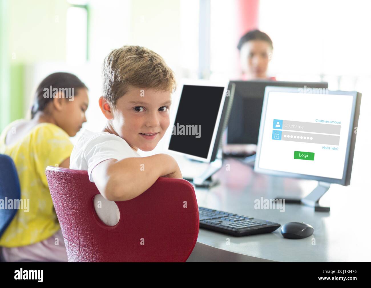 Digital composite of Happy boy in computers class Stock Photo - Alamy