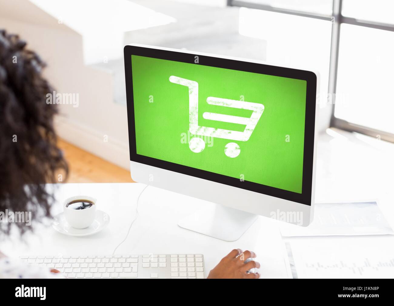 Digital composite of Person using Computer with Shopping trolley icon ...