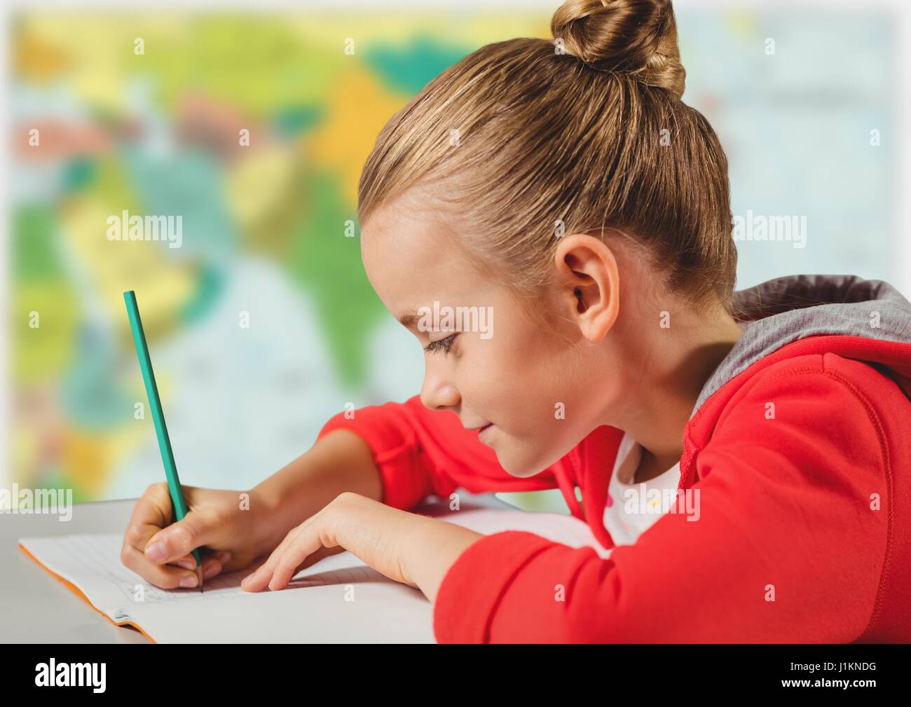 Digital composite of Girl doing homework against blurry map Stock Photo ...