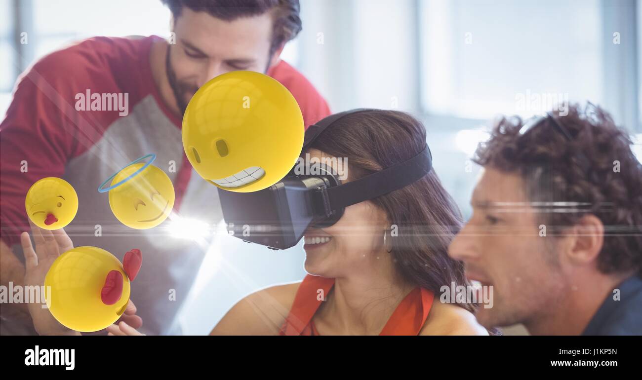 Digital composite of Happy businesswoman looking at emojis on VR ...