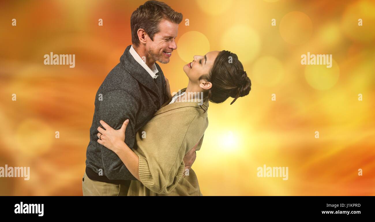 Digital composite of Romantic man embracing woman over blur background ...