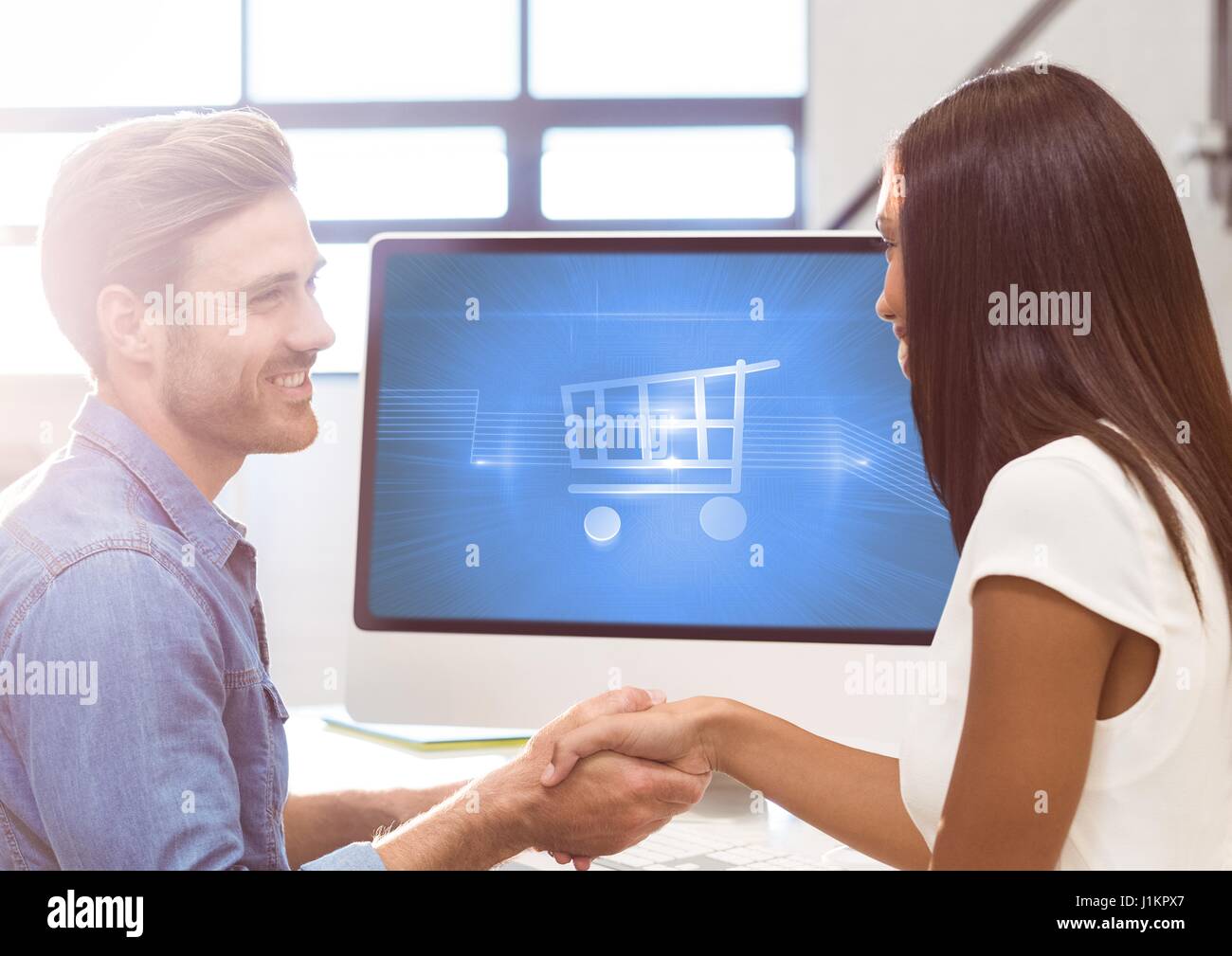 Digital composite of Two People using computer with Shopping trolley ...