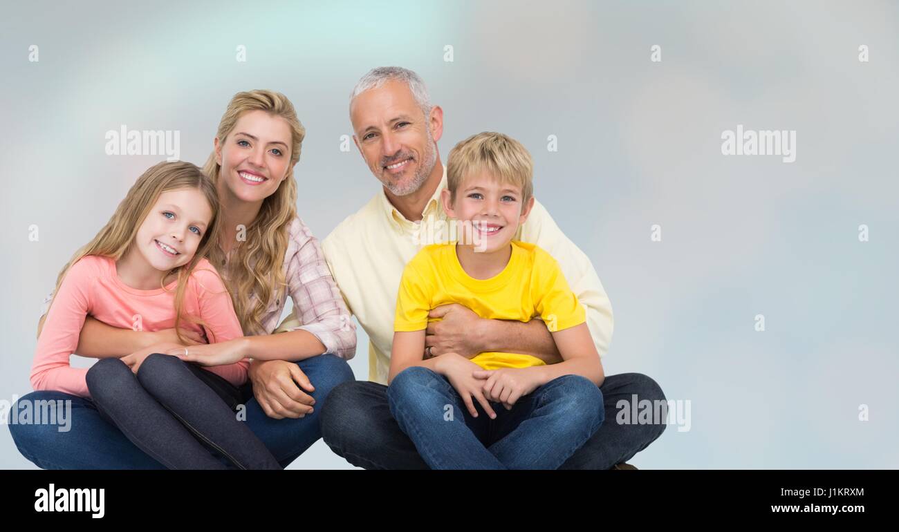 Digital composite of Happy family sitting over blur background Stock ...