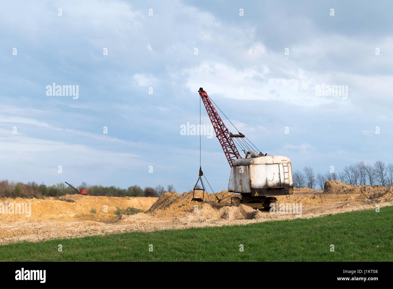 excavator in the red clay quarry Stock Photo - Alamy