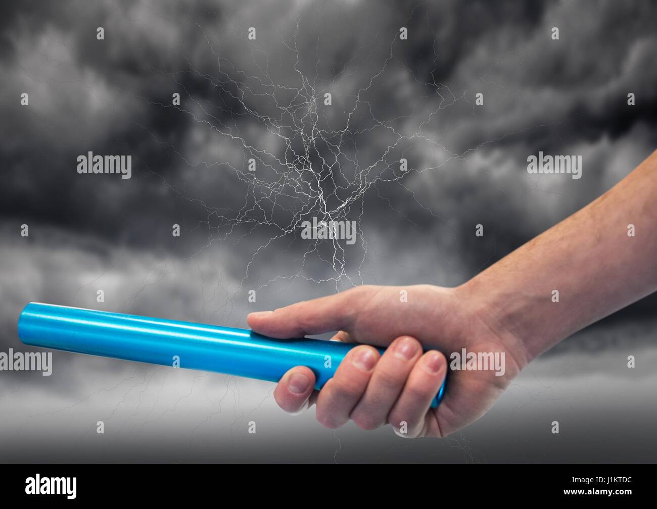 Digital composite of Hand with blue baton and lightning against stormy ...