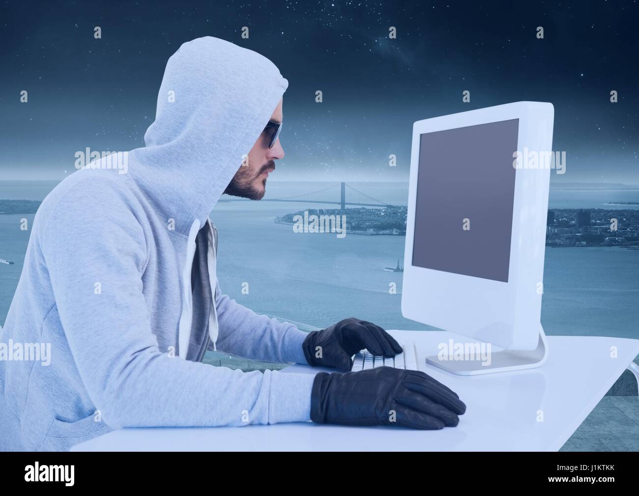 Digital composite of Criminal Man in hood on computer in front of ...
