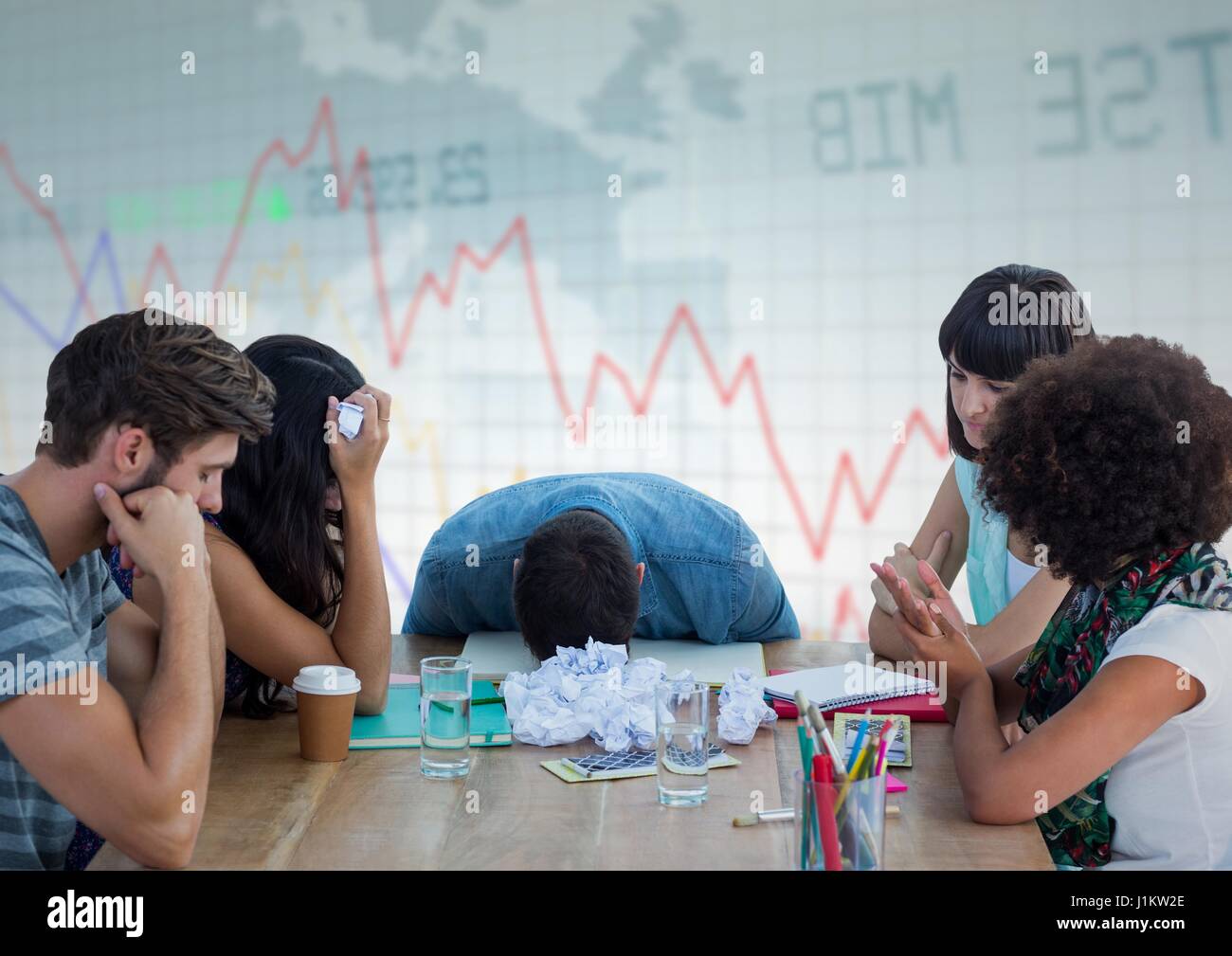 Digital composite of People bored at meeting against downward graph ...