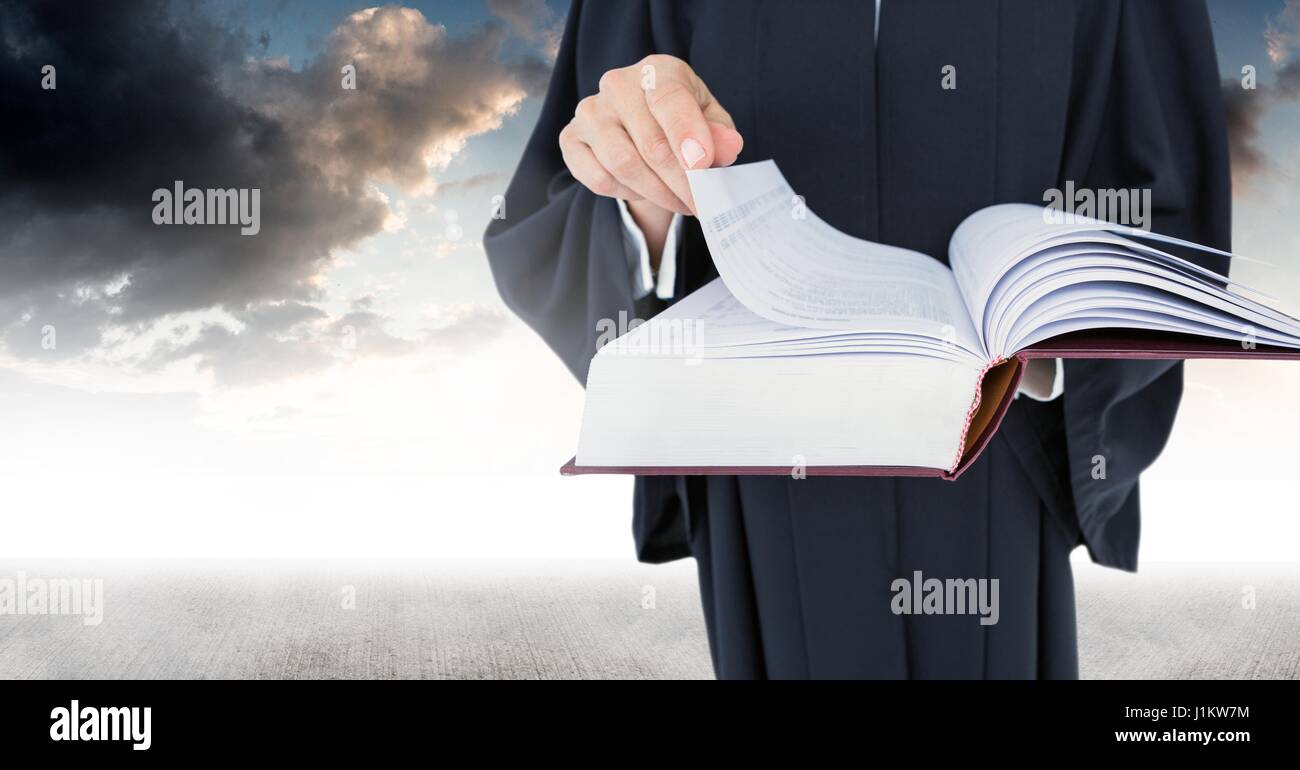 Digital composite of Judge holding book in front of sky clouds Stock ...