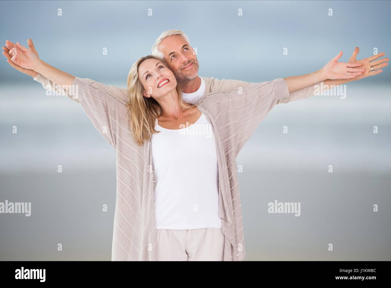 Digital composite of Affectionate couple with arms outstretched ...