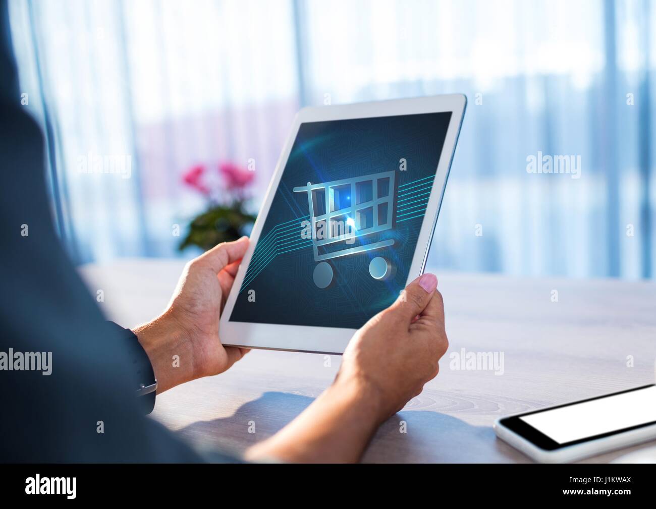 Digital composite of Person using Tablet with Shopping trolley icon ...
