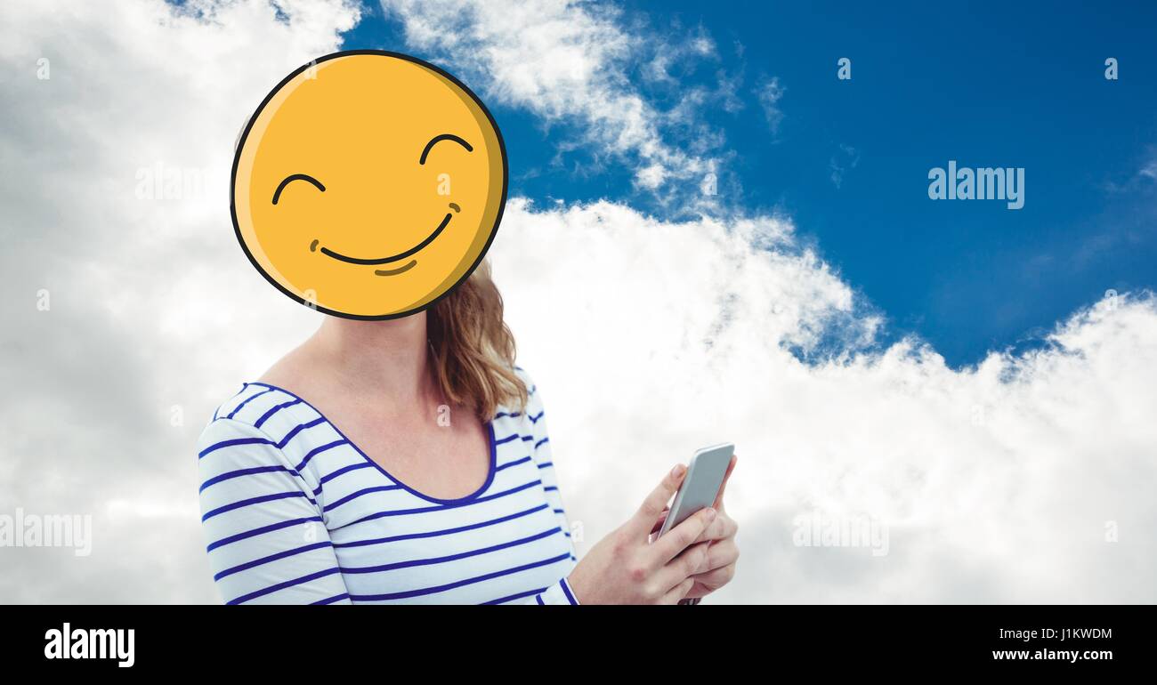 Digital composite of Woman with emoji over face using smart phone ...