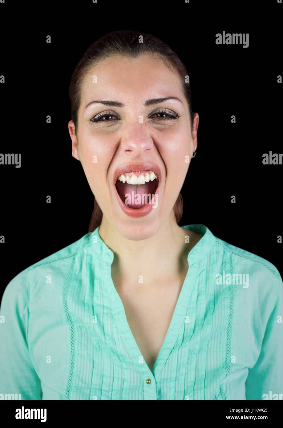 Digital composite of Woman screaming with black hat against black ...