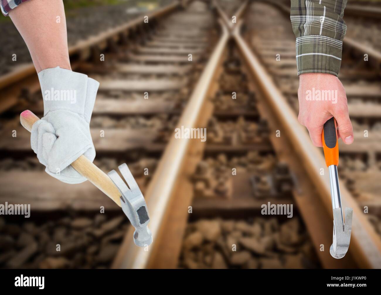Digital composite of hands with hammers in the railroad tracks Stock ...