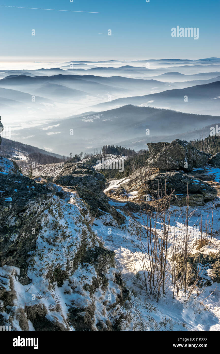 Misty mountains from the rock - portrait Stock Photo - Alamy
