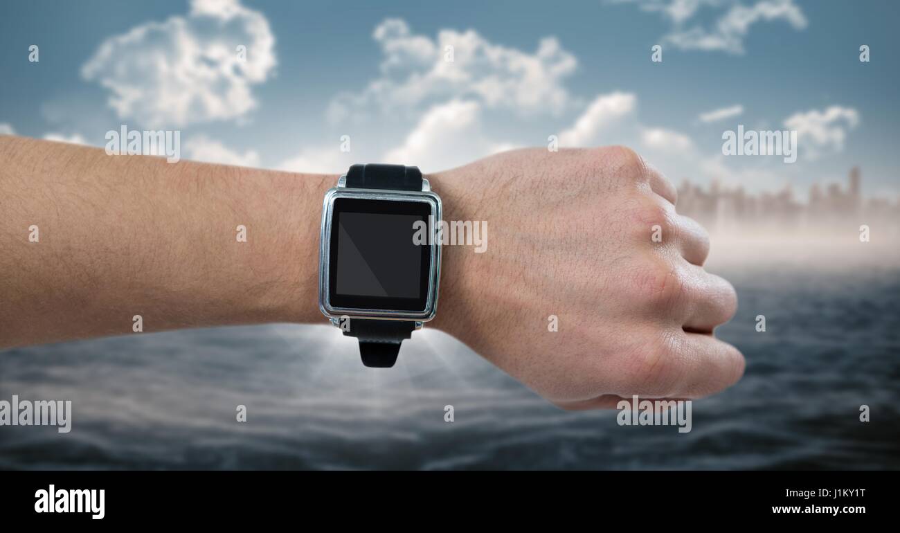 Digital composite of Hand with watch and flare against blurry skyline ...
