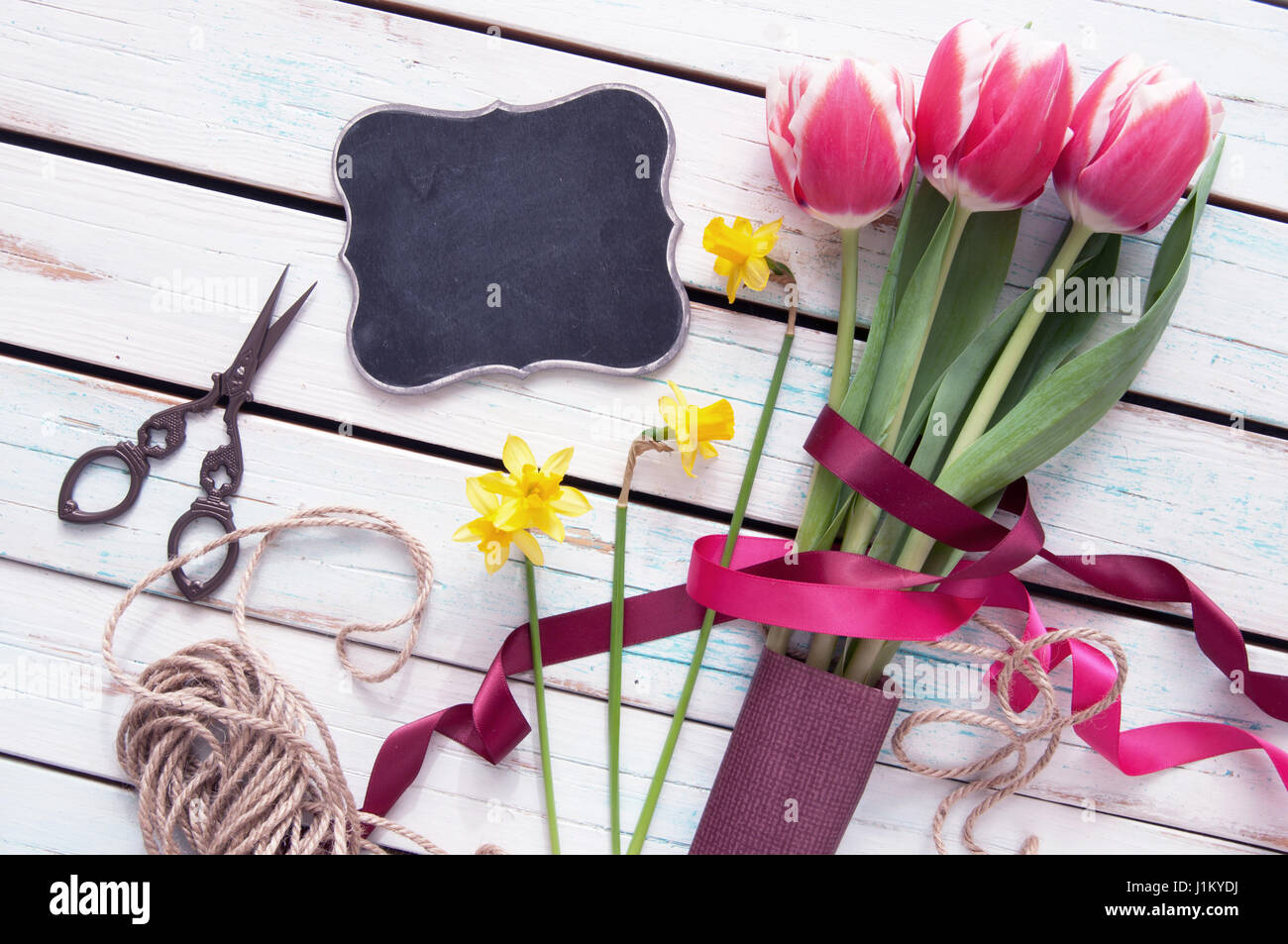 Spring tulips with small blackboard sign Stock Photo - Alamy