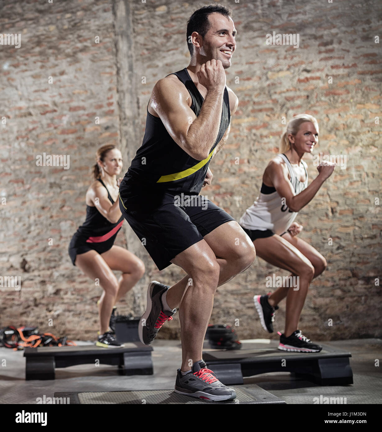 step group training, smiling people doing exercise Stock Photo - Alamy