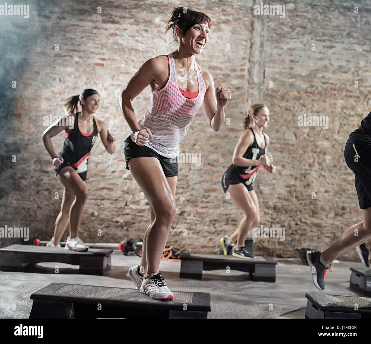 positive and cheerful people doing exercise on steppers Stock Photo - Alamy