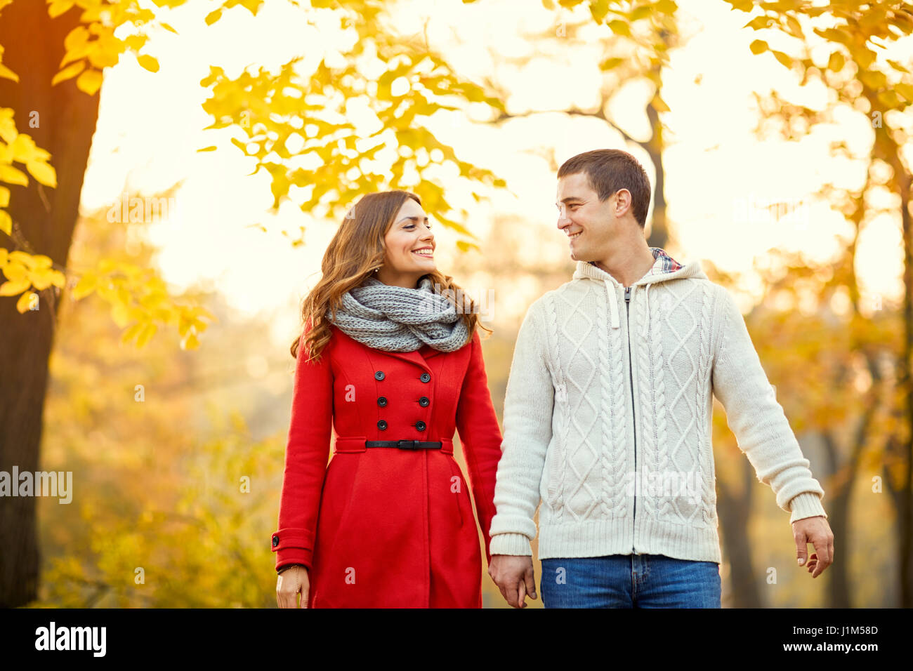 Romantic couple walking in park in autumn Stock Photo - Alamy