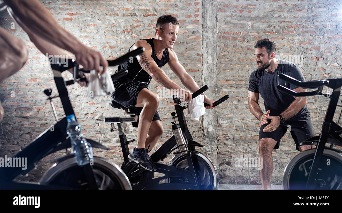 Bicycle spinning, young people on exercise bicycle Stock Photo - Alamy