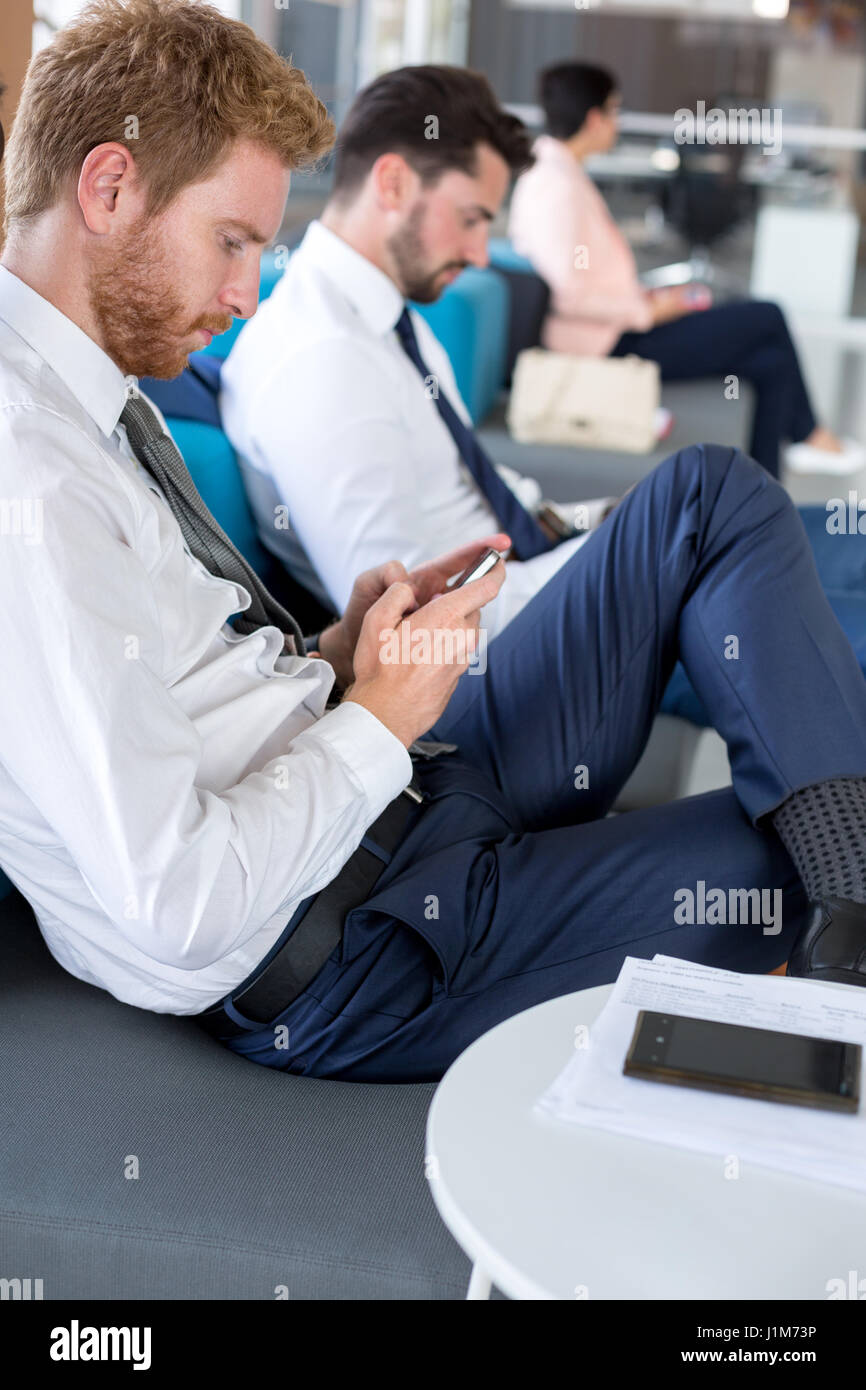 Young businessman wait airplane on airport in waiting room Stock Photo ...