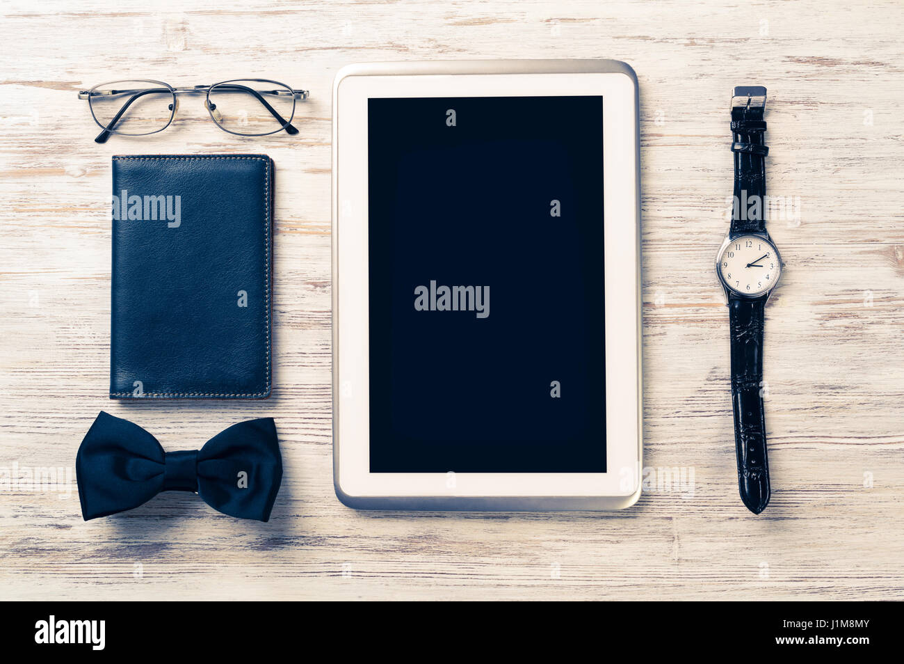 Gentleman kit of tablet watch glasses bow tie and notebook on wo Stock ...
