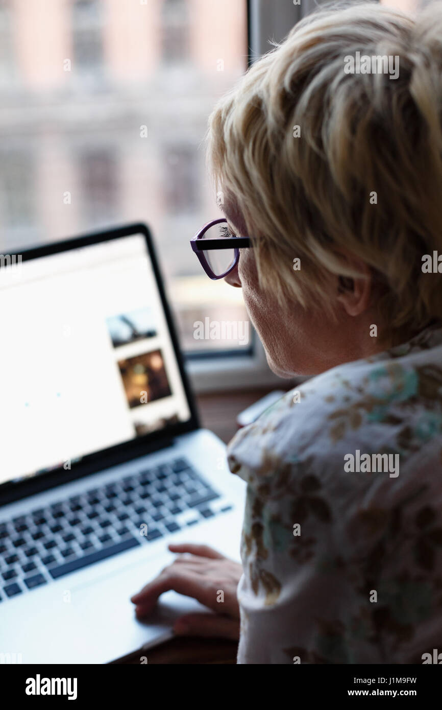 Old woman browsing internet using hi-res stock photography and images ...