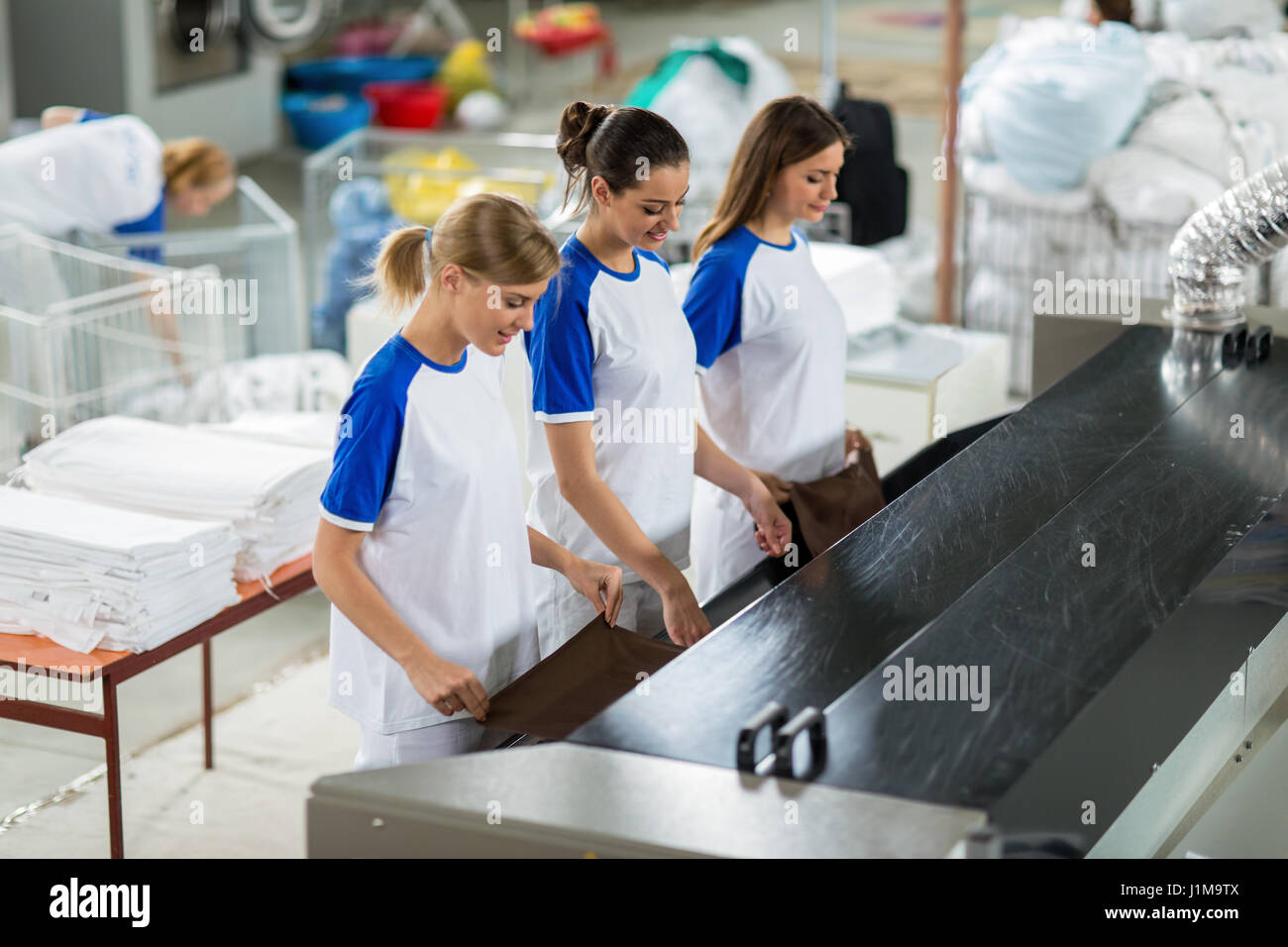 Woman with pressing machine working Stock Photo - Alamy