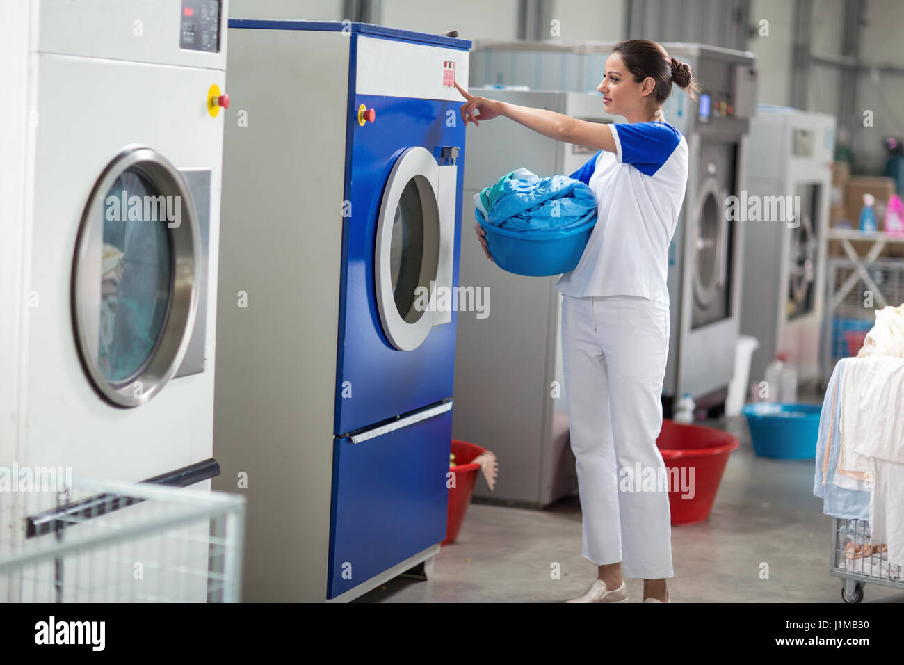 Employees including washing machines in washing machine Stock Photo - Alamy