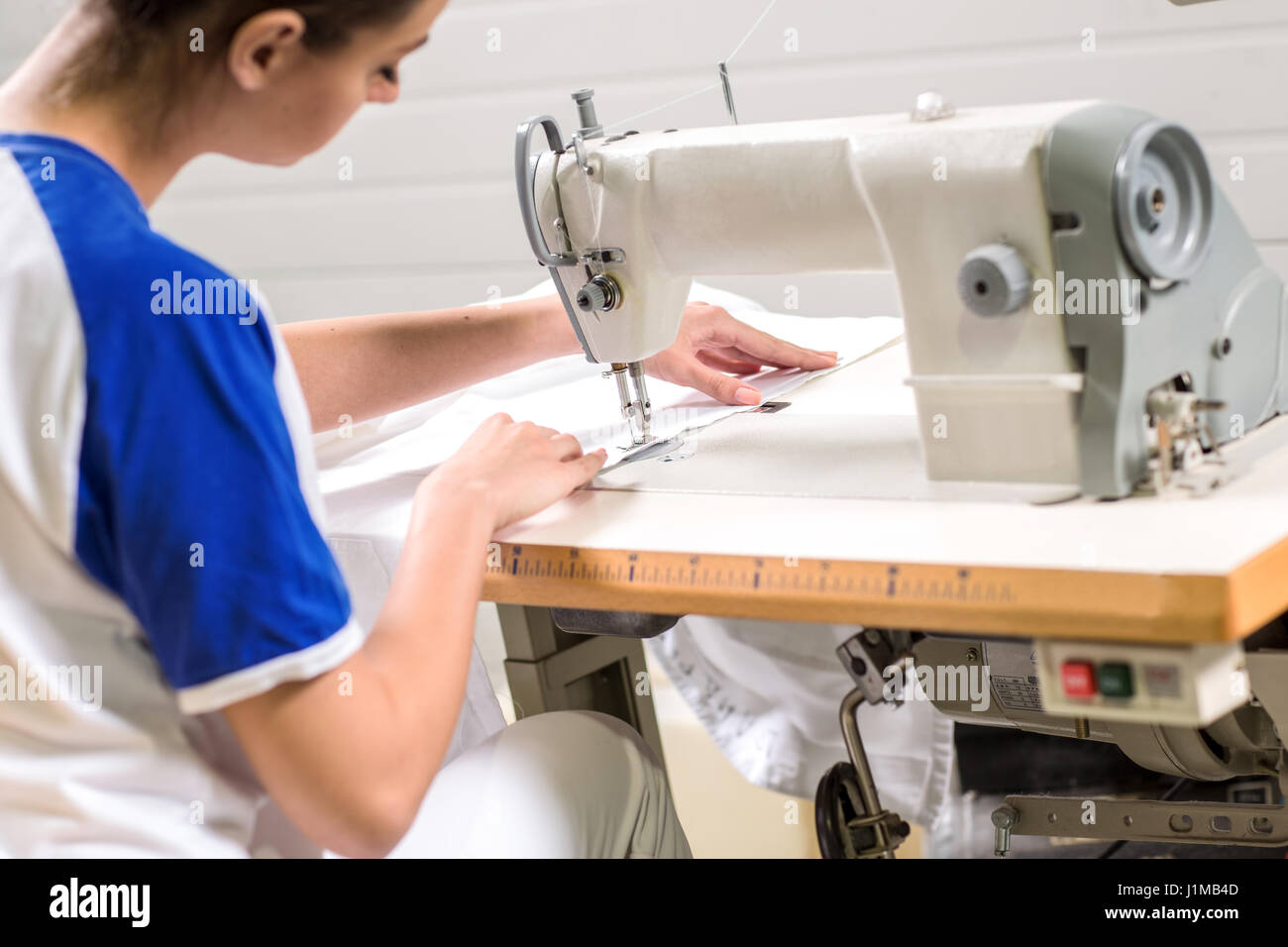 Tailor sewing with sewing machine Stock Photo - Alamy