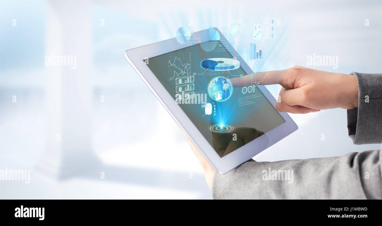 Digital composite of Hands touching tablet and blue graphics and flares ...