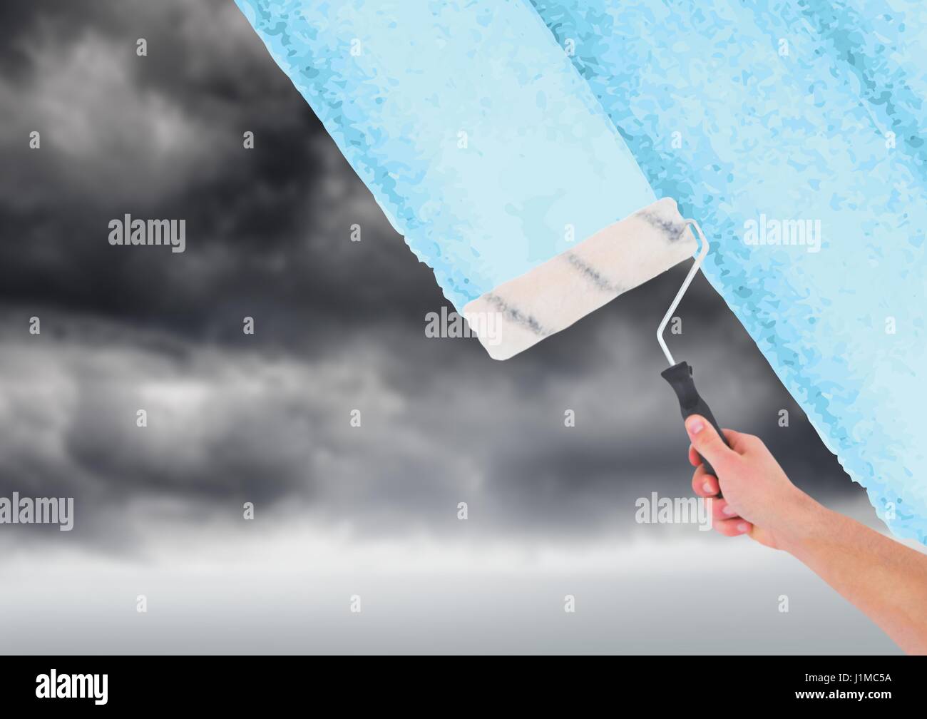 Digital composite of Hand with roller painting the sky Stock Photo - Alamy