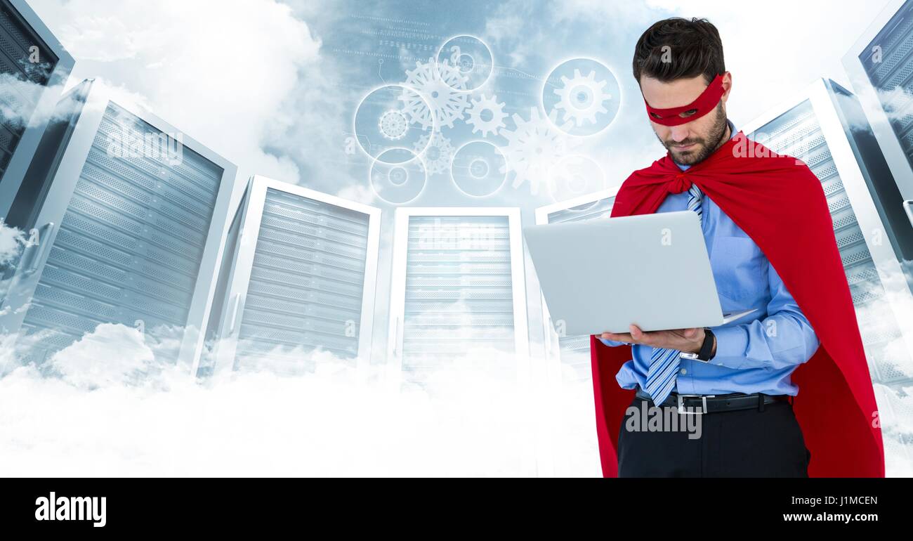 Digital composite of Business man superhero with laptop against servers ...