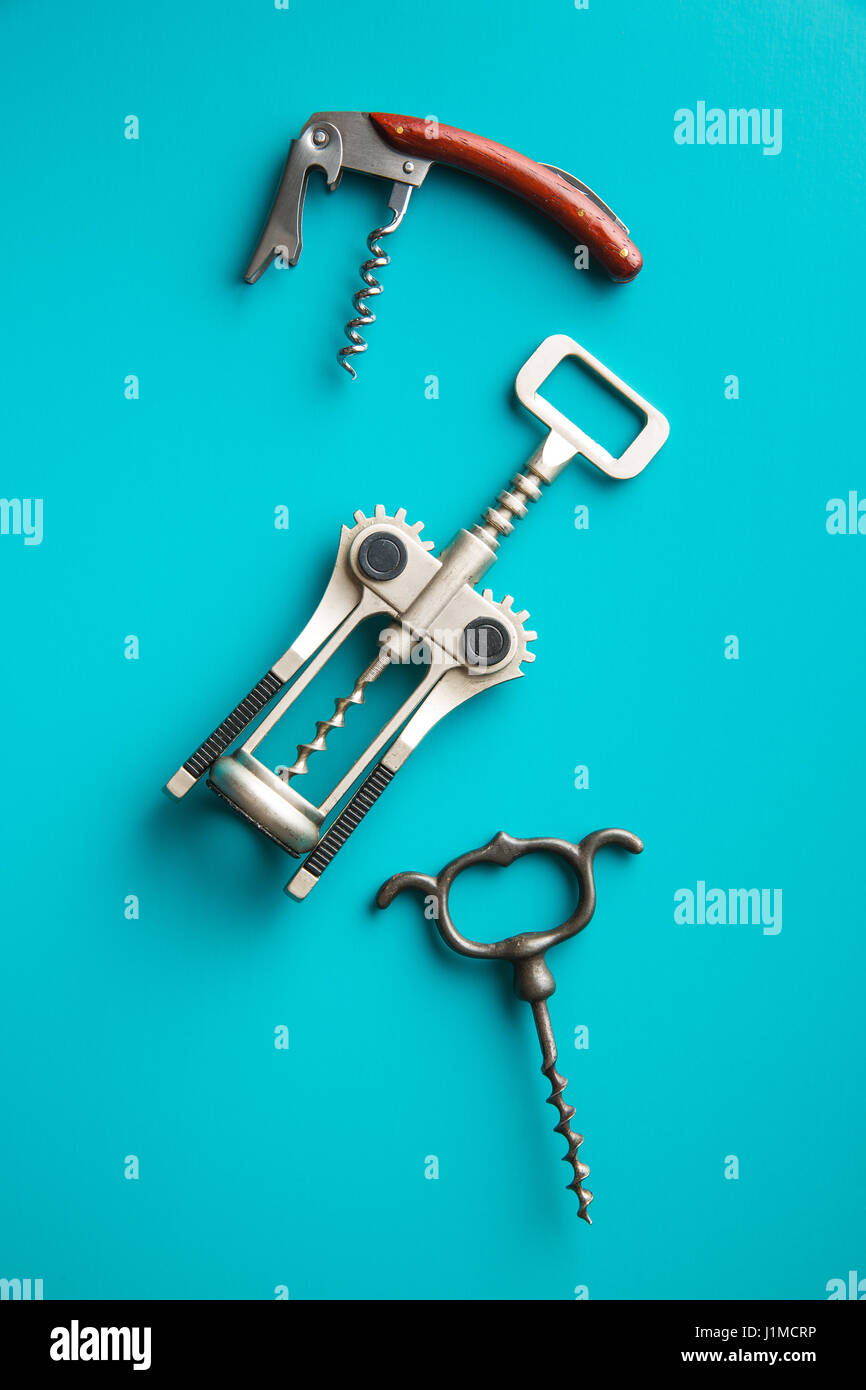 Various types of corkscrews on blue background Stock Photo - Alamy