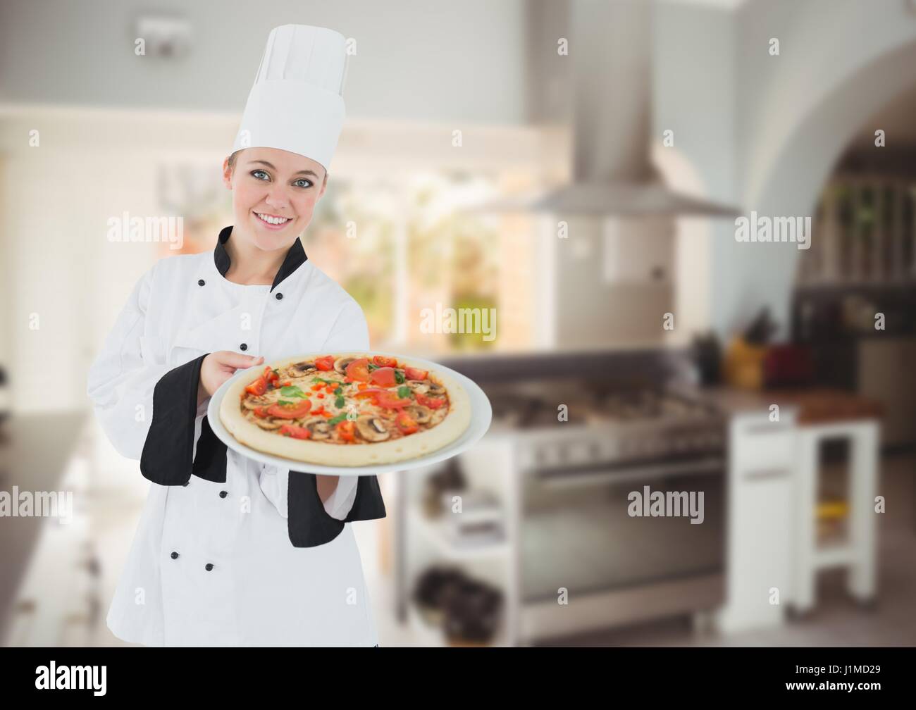 Digital composite of Happy chef showing the pizza in the kitchen Stock ...