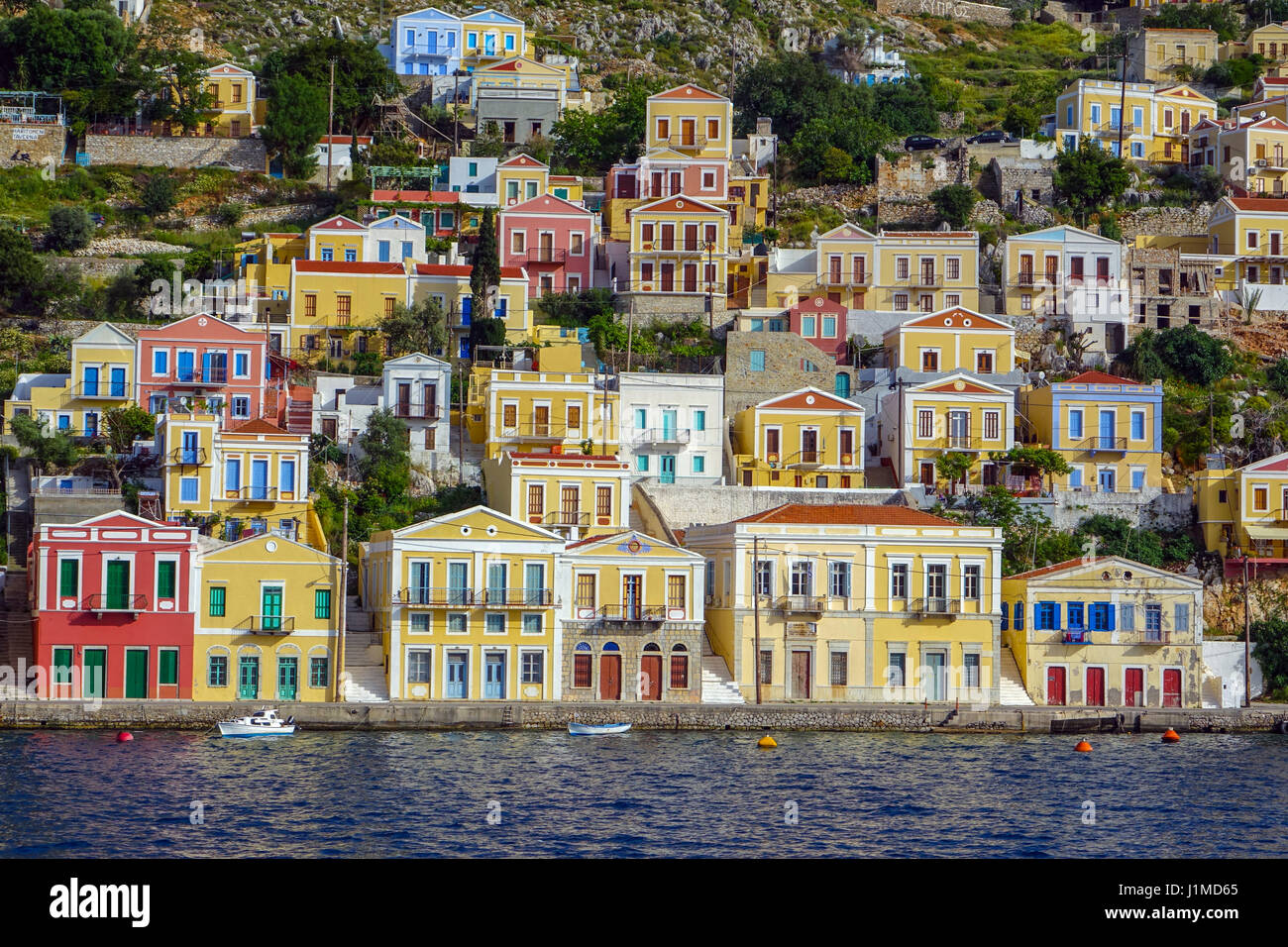 Colourful waterfront houses on Symi Simi, Greece Stock Photo - Alamy