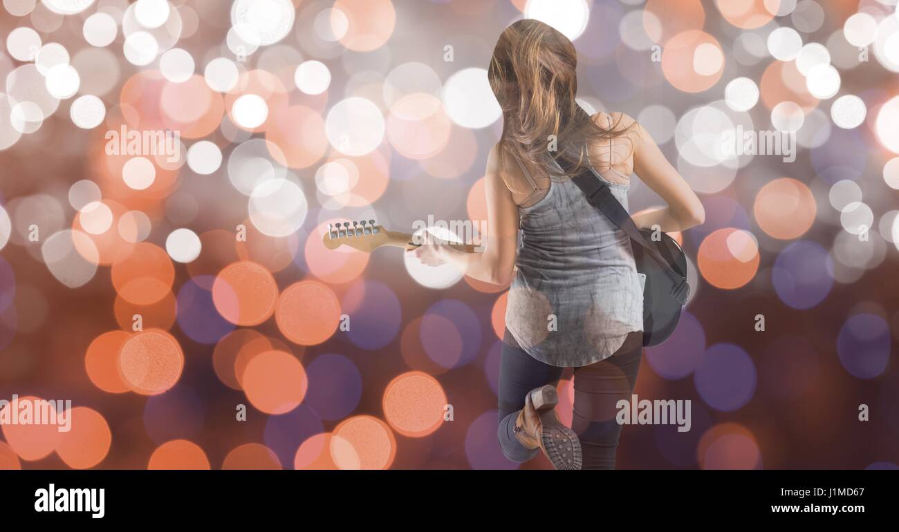 Digital composite of Rear view of music artist playing guitar over ...