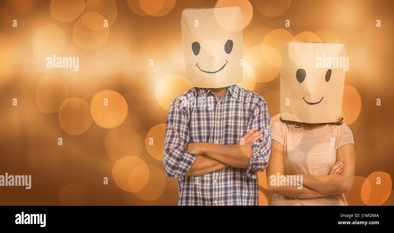 Digital composite of Couple covering faces with paper bag with smileys ...