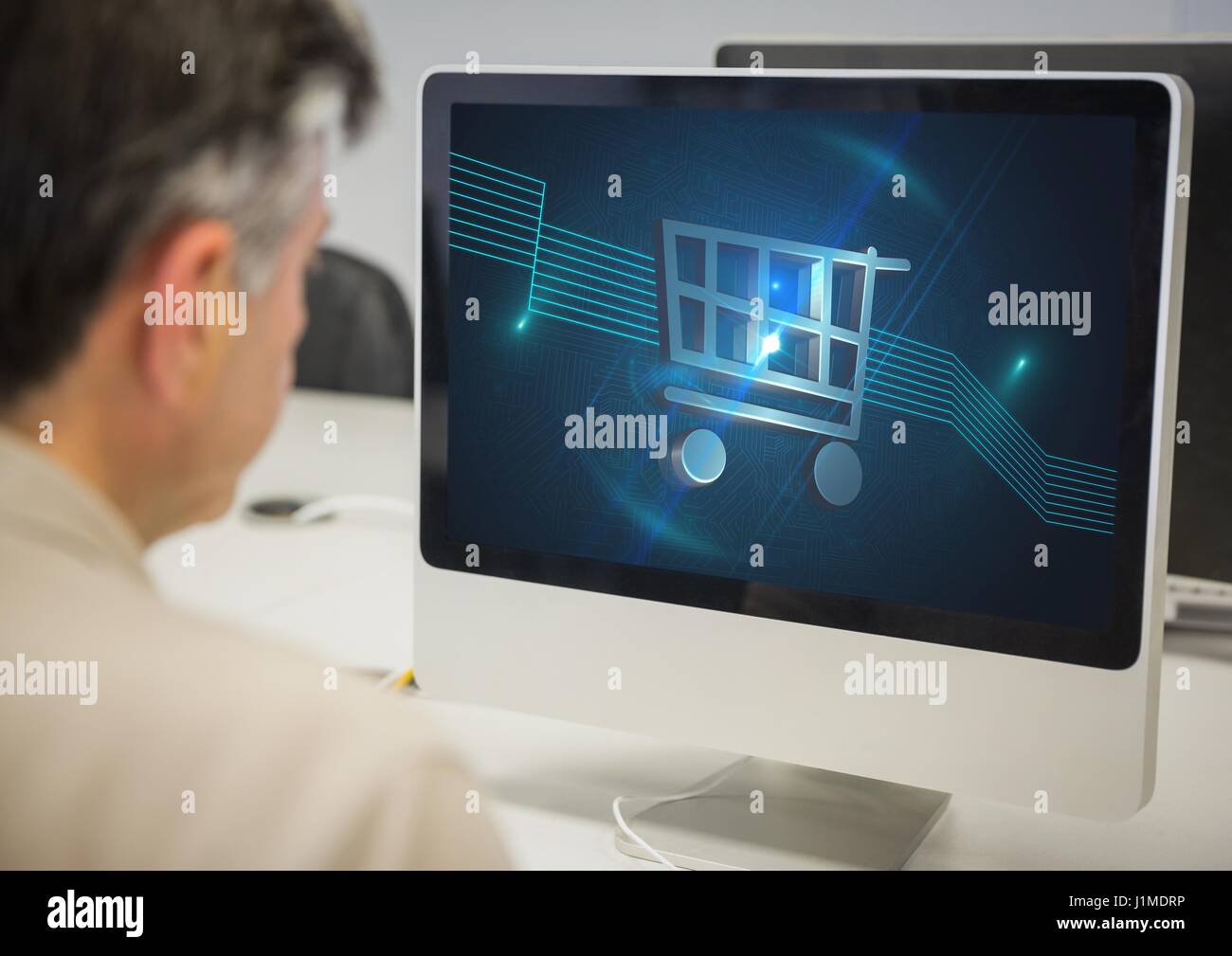 Digital composite of Man using Computer with Shopping trolley icon ...