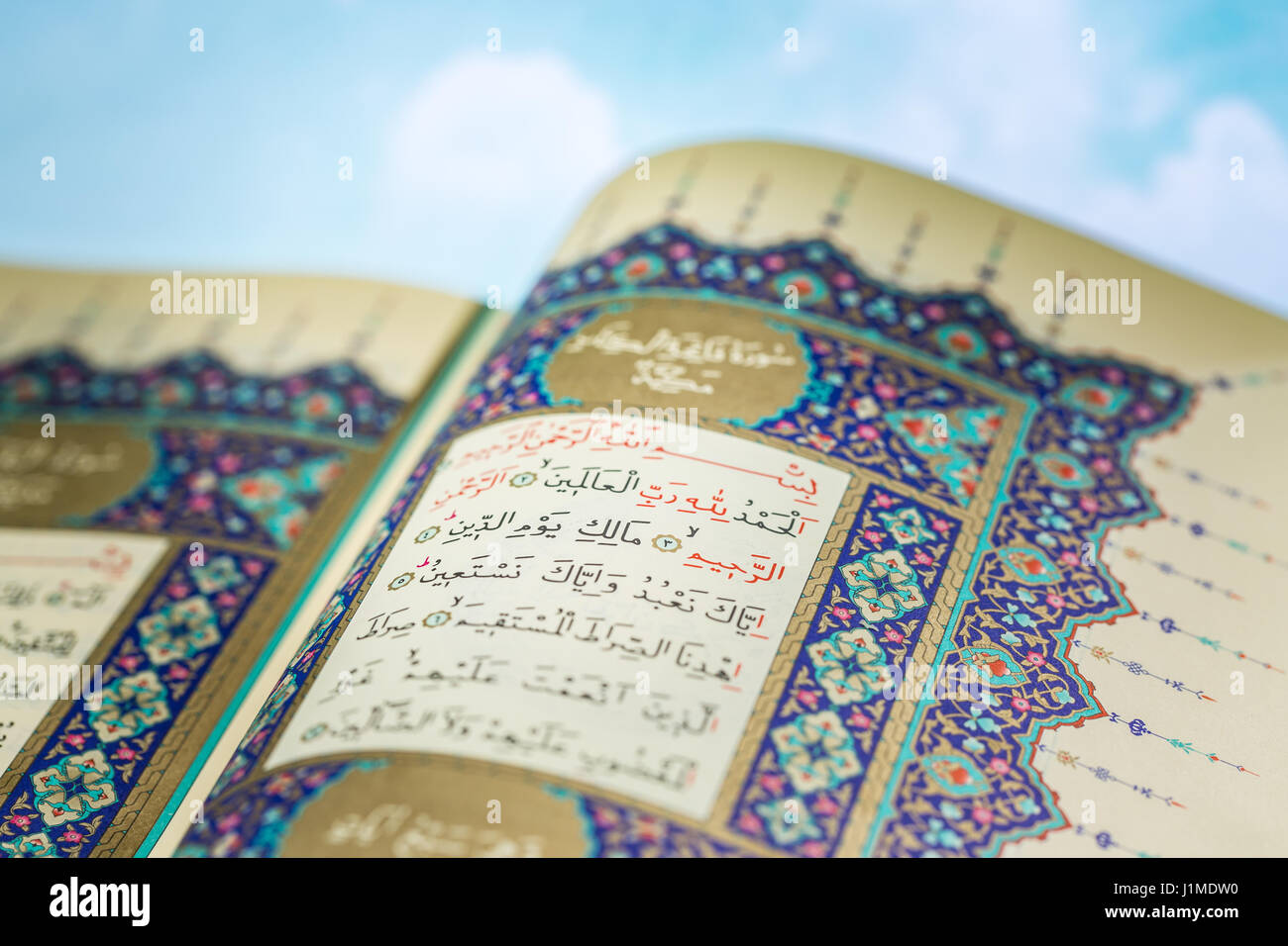 Opening pages of holy book Qur'an with cloudOpening pages of holy book ...