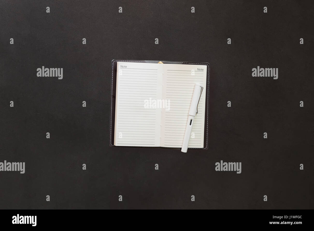 Above Writing paper notepad and pen on a black leather texture Stock ...