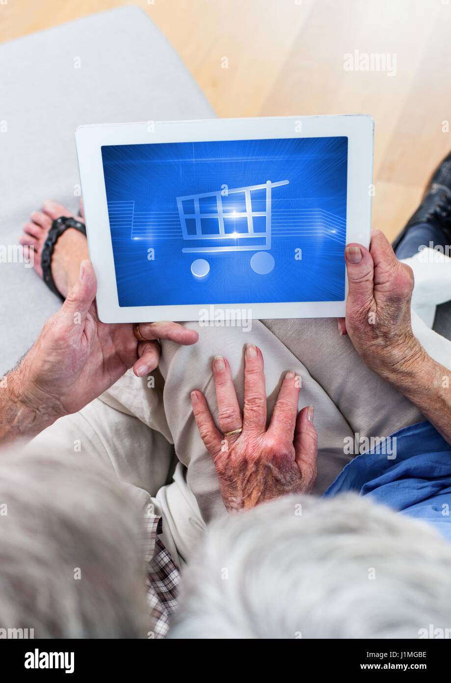 Digital composite of Old People using Tablet with Shopping trolley icon ...