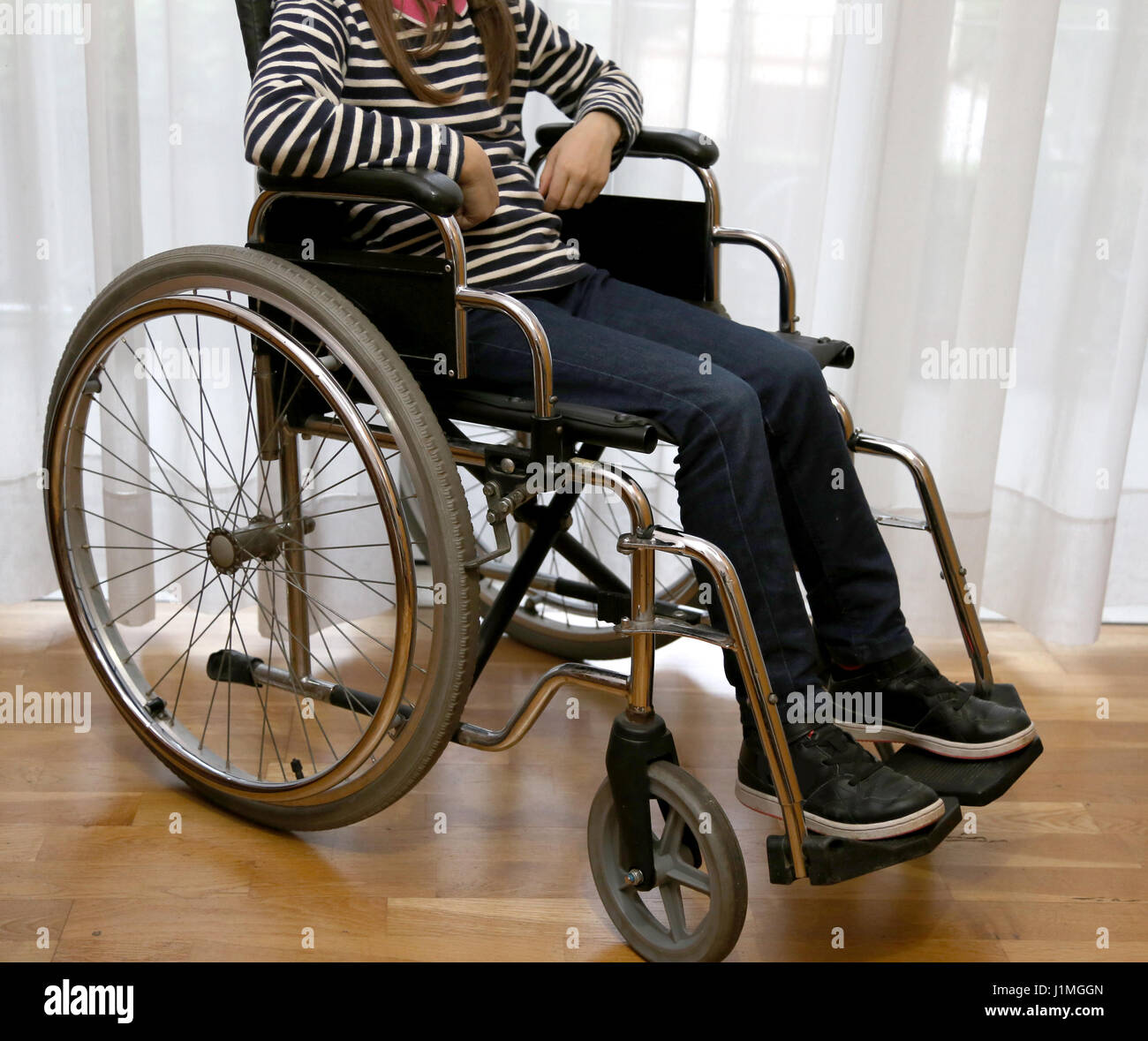 disabled little girl in a wheelchair in her bedroom Stock Photo - Alamy
